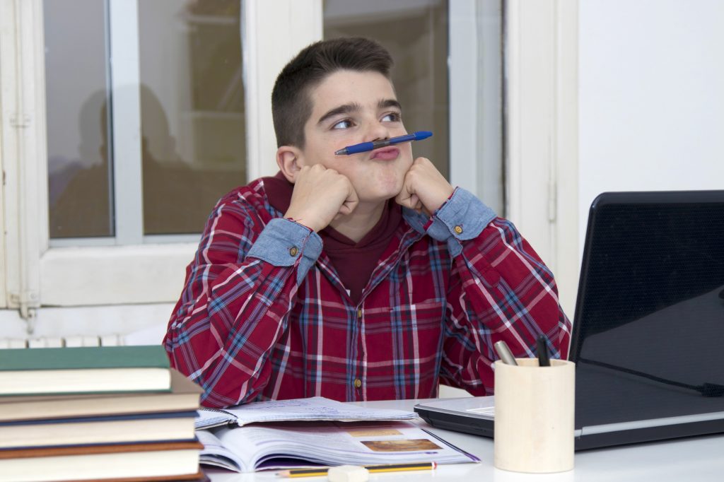 child distracted thinking on the desk of the school or home — The James ...