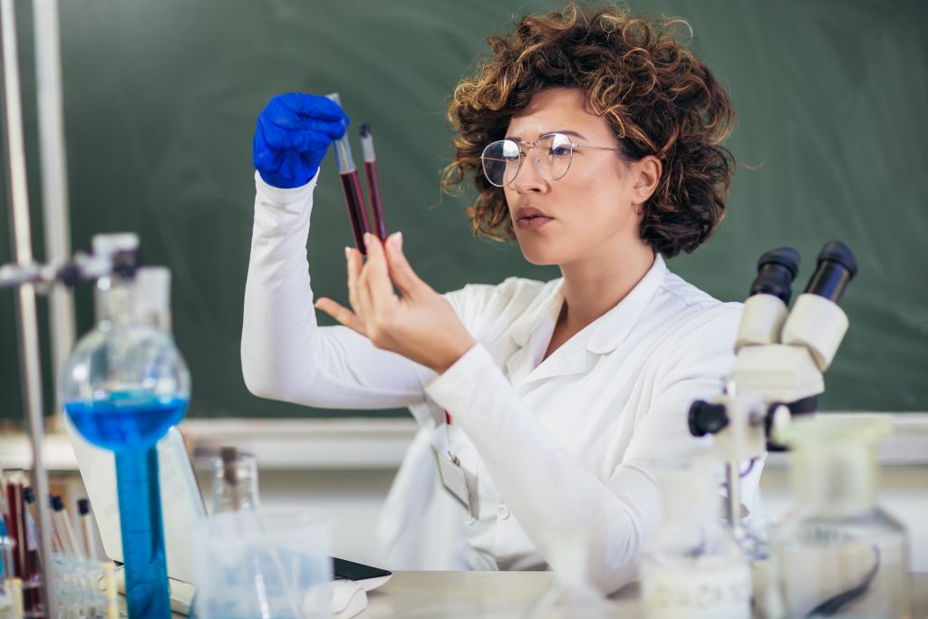 Lab technician assistant analyzing a blood sample at laboratory ...