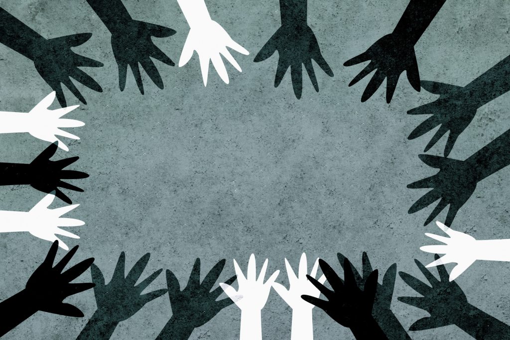 Hands of different colors and cultures of the world unite in a circle ...